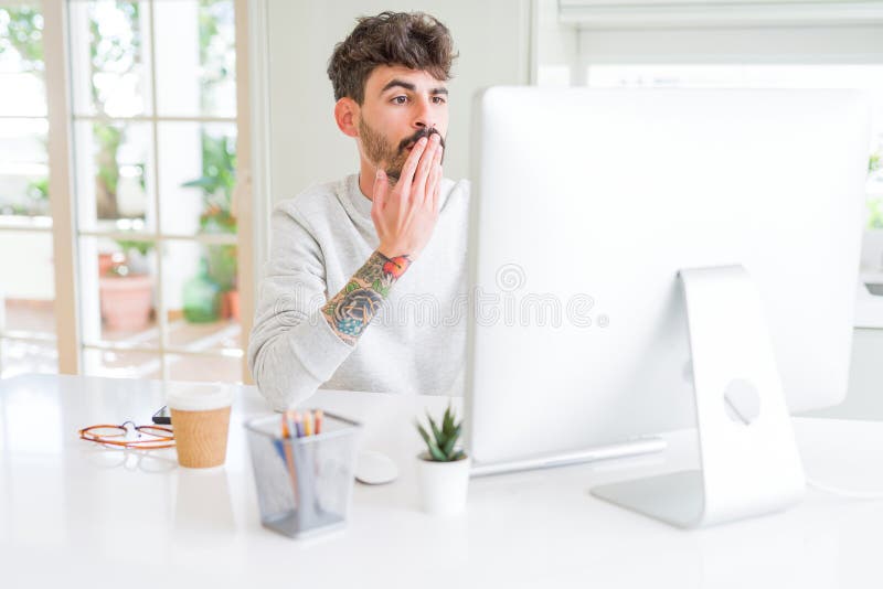 Young Man Working Using Computer Cover Mouth with Hand Shocked with ...