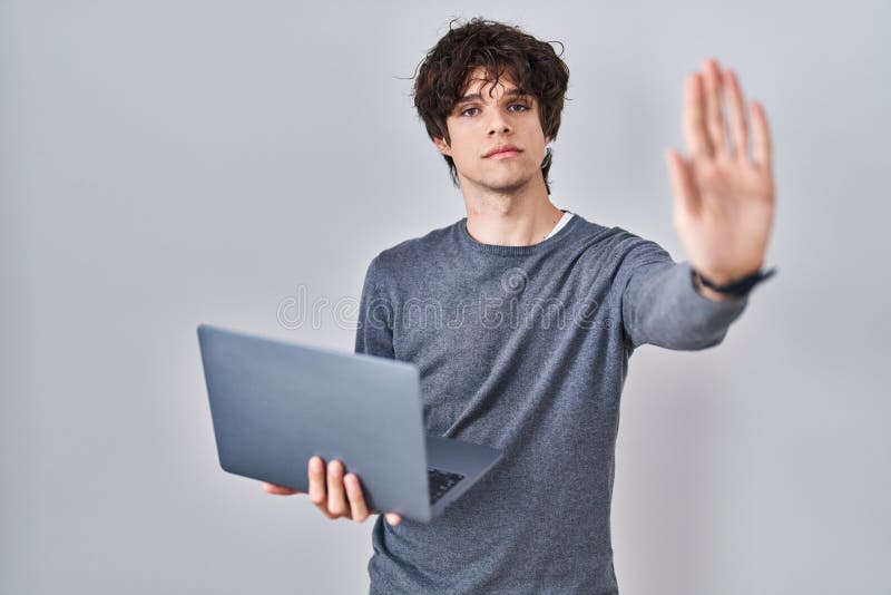 Young Man Working Using Computer Laptop with Open Hand Doing Stop Sign ...
