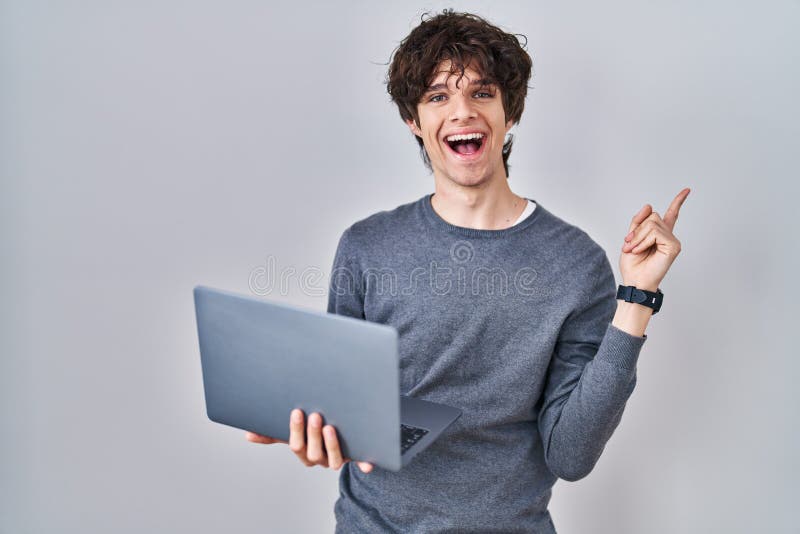 Young Man Working Using Computer Laptop Smiling Happy Pointing with ...