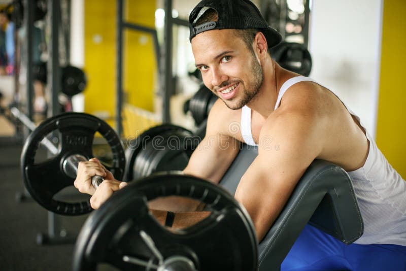Young man workout in gym. stock image. Image of lying - 98508547