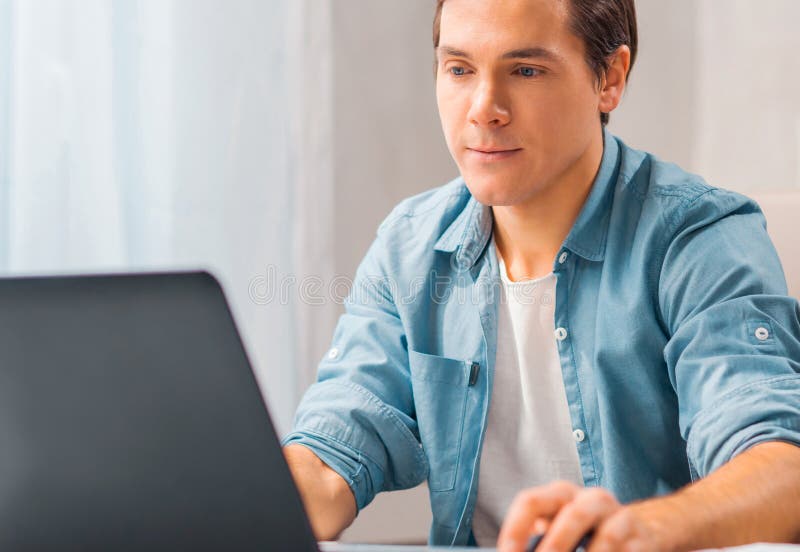 Young Man Works at a Laptop Computer. Freelancer, Remote Worker or ...