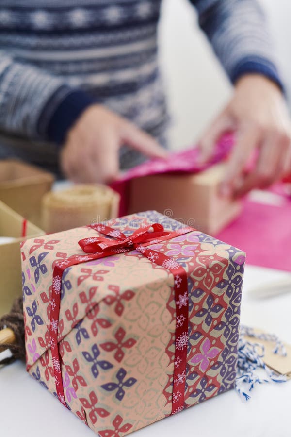 Young man wrapping a gift stock image. Image of handmade - 81909223