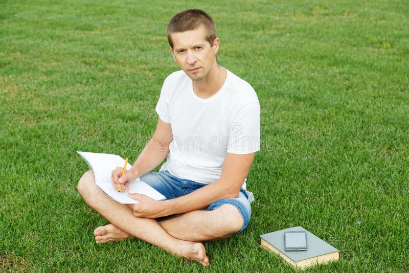 The Young Man Writes To a Notebook Stock Photo - Image of dreams, jeans ...