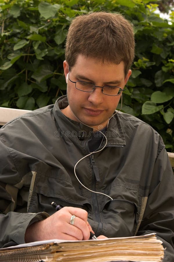 Young man writing stock image. Image of jacket, notes - 3136717