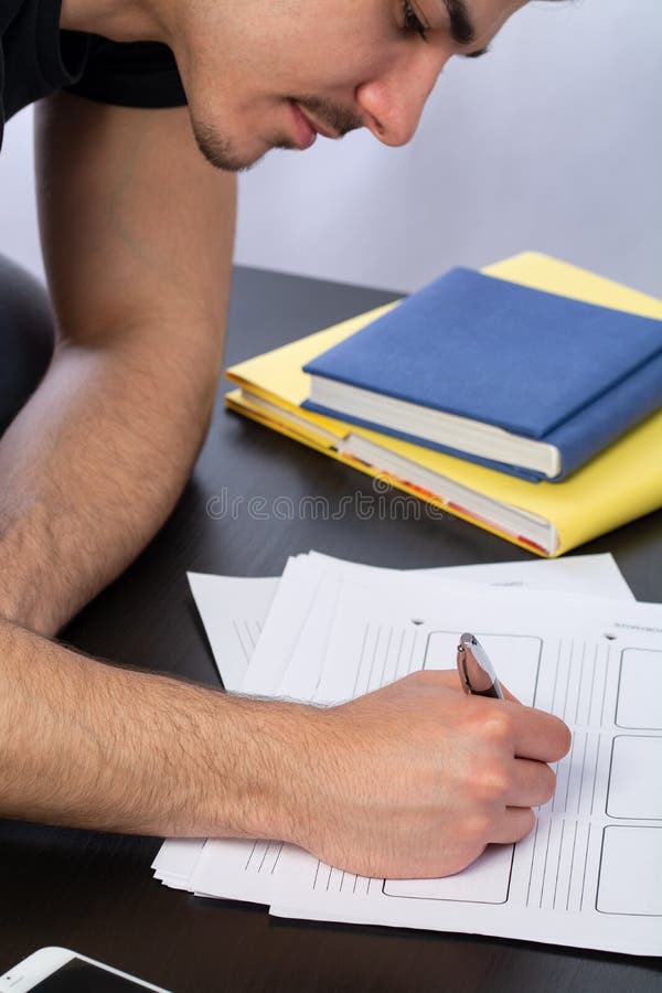 Young man writing stock photo. Image of note, success - 115536414
