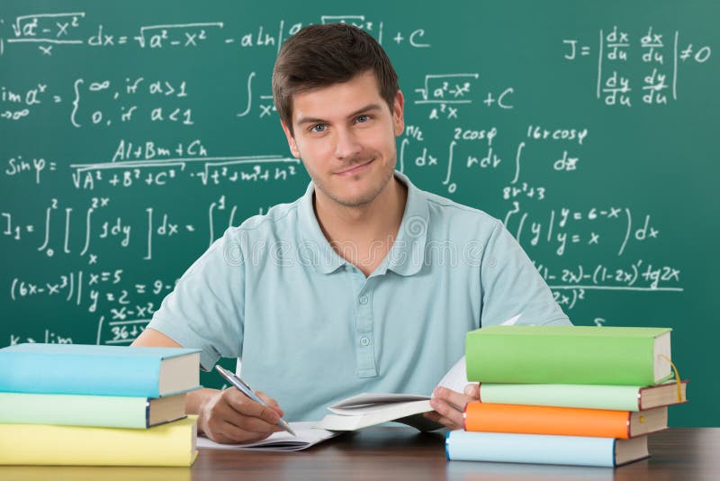 Young Man Writing in Book stock image. Image of research - 77508977