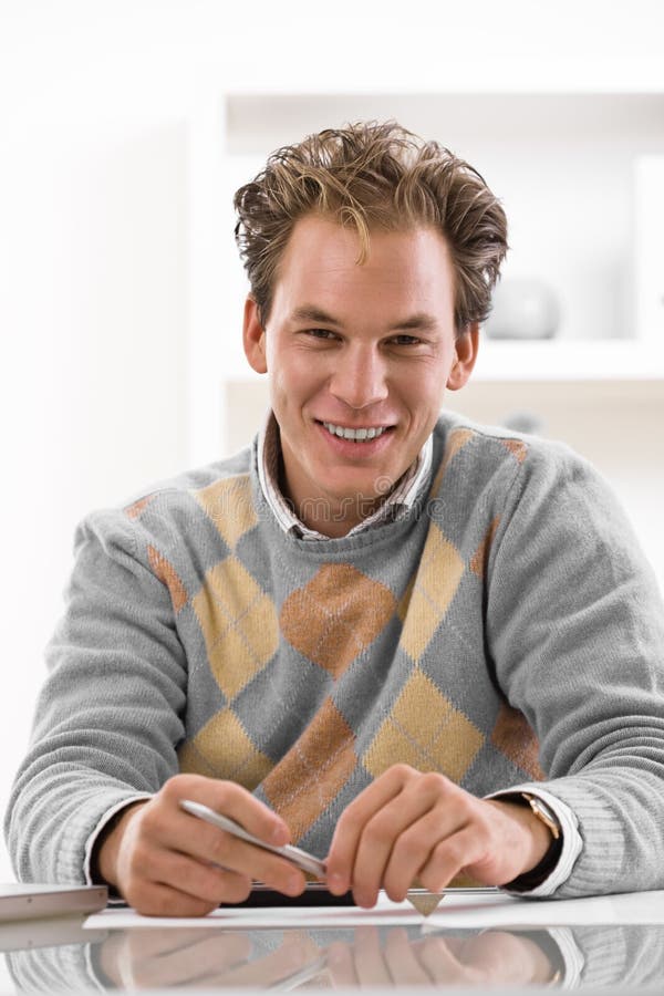 Young man writing at desk stock image. Image of caucasian - 8377695