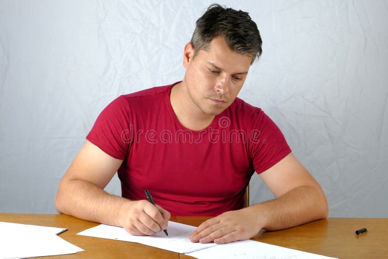 Young man writing stock photo. Image of attractive, paper - 81839966