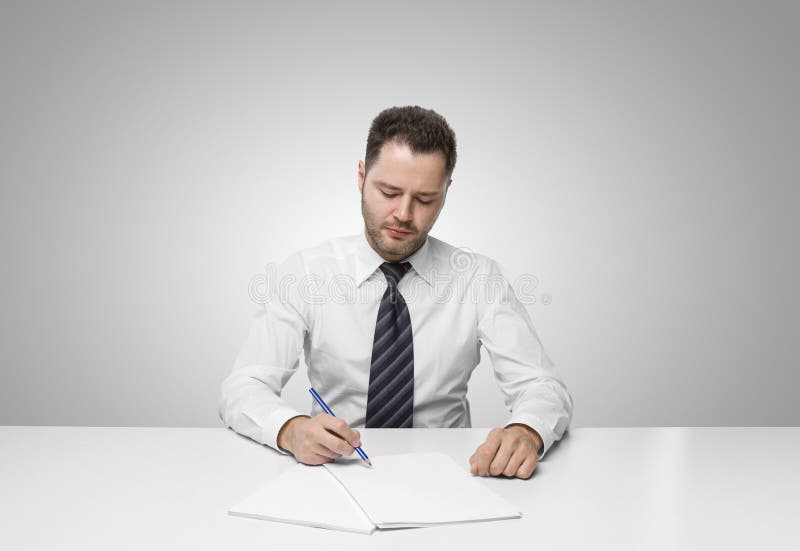 Young man writing on paper stock image. Image of people - 32989949