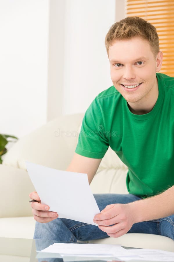 Young Man Writting and Holding Paper. Stock Image - Image of ...