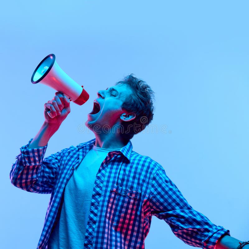 Young Man Yelling into Megaphone with All His Strength and Emotion in ...