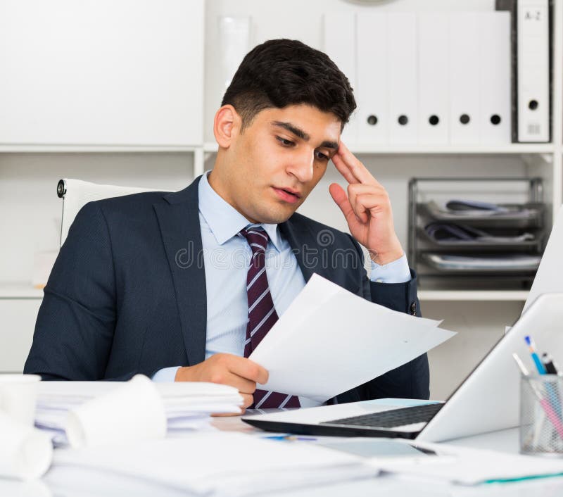 Young Manager is Reading Documents about the Transaction Stock Photo ...