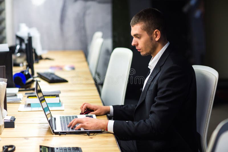 Young Manager at the Workplace. Young Man Working on Computer in Office ...
