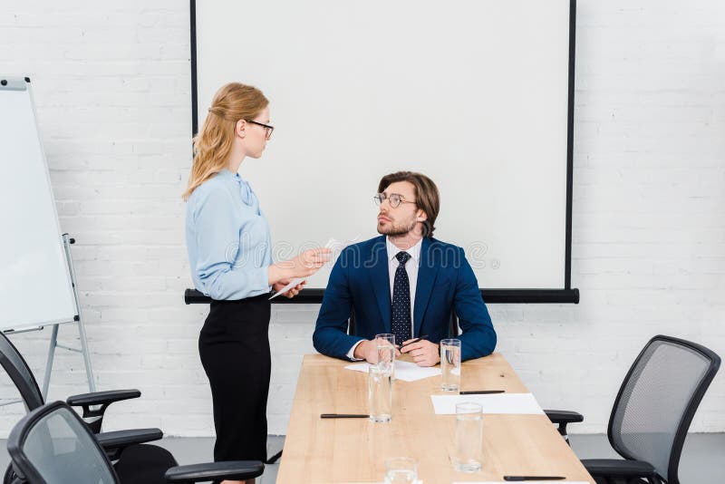 Young Manageress with Documents Talking To Her Boss Stock Photo - Image ...