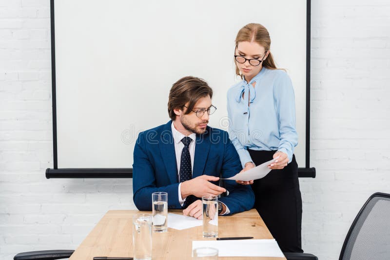 Young Manageress Showing Documents To Her Boss Stock Photo - Image of ...