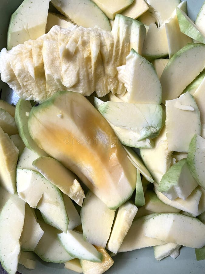 Young Mangoes Cut into Small Pieces are Placed on Top of the Container ...