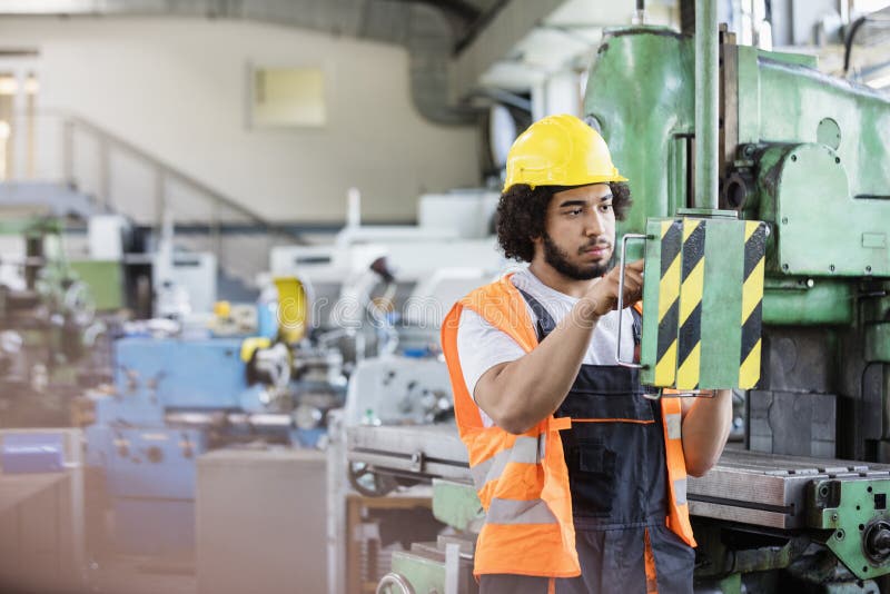 Young Manual Worker Operating Machinery in Metal Industry Stock Image ...