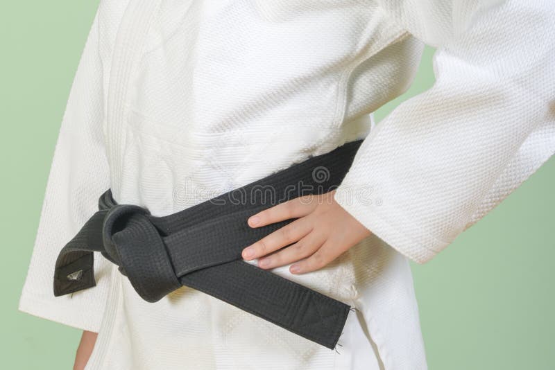 White Judo Gi. a Young Martial Arts Master Knots a Black Belt. Stock ...