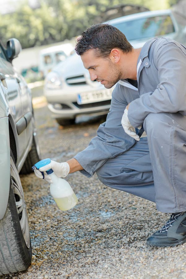 Young Mechanic Cleaning Wheel Stock Photo - Image of tyre, background ...