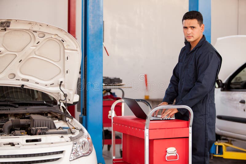 Young Mechanic Using a Computer Stock Photo - Image of mechanic, hood ...