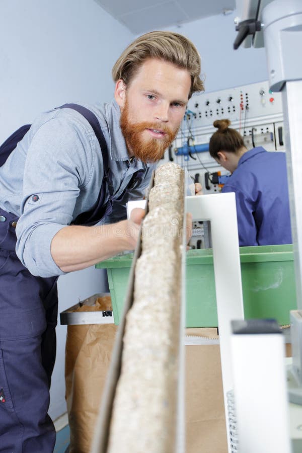 Young Mechanical Worker Looking at Machine Stock Photo - Image of ...