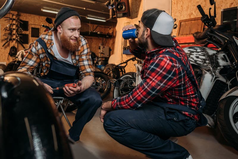 Young Mechanics Having Break in Work Stock Image - Image of machine ...
