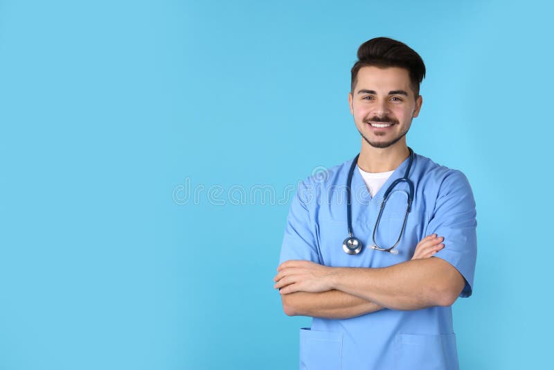 Young Medical Student in Uniform on Color Background. Stock Photo ...