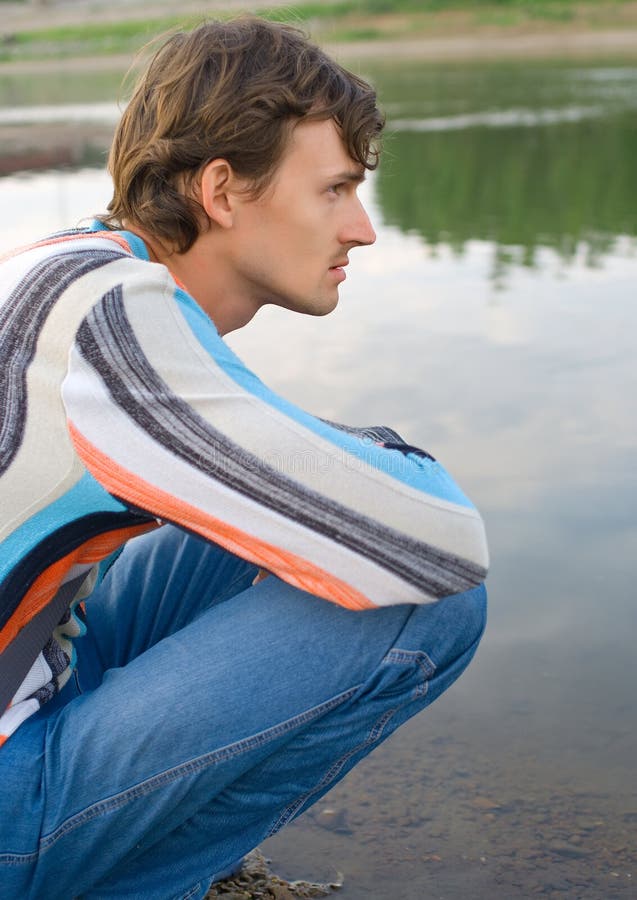 Young Men Against Coast of River Stock Photo - Image of river, sits ...