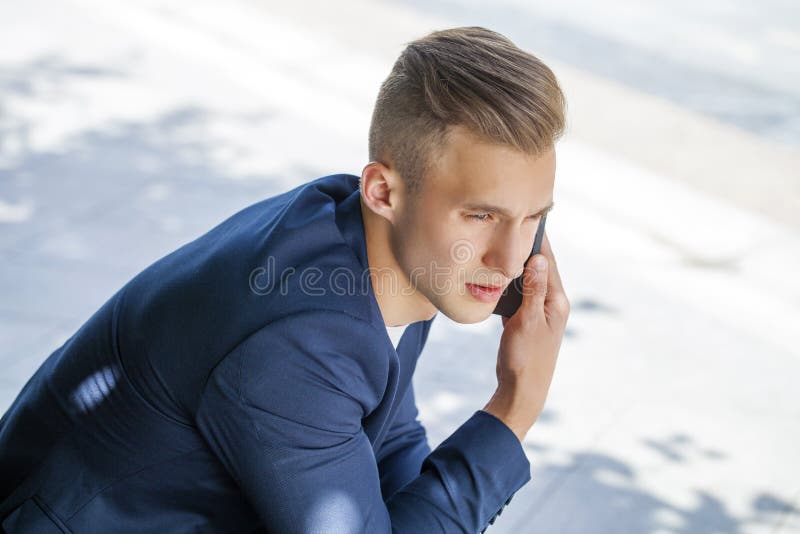 Young men calling by phone stock image. Image of calm - 61127115