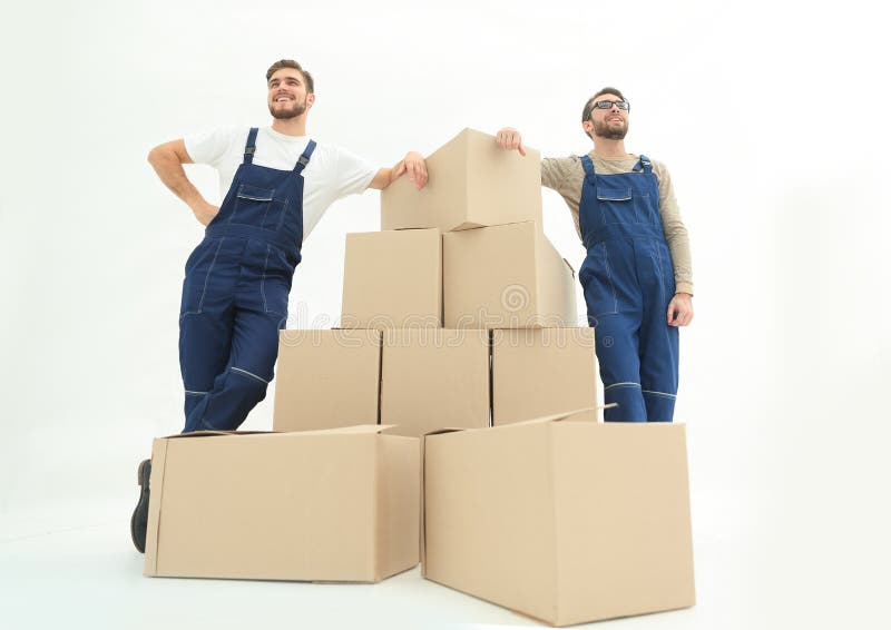 Young Men Carrying a Box To the Pile of Boxes. Stock Photo - Image of ...