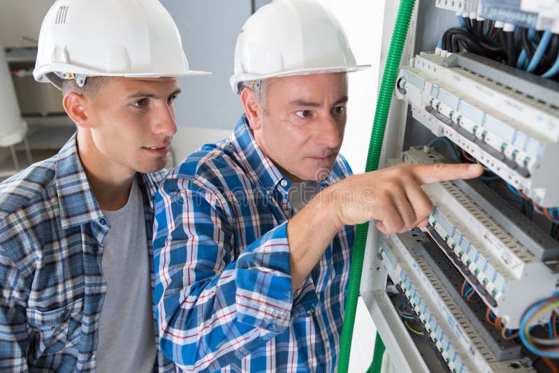 Young Man Doing Work on Panel Board with Instructor Stock Image - Image ...
