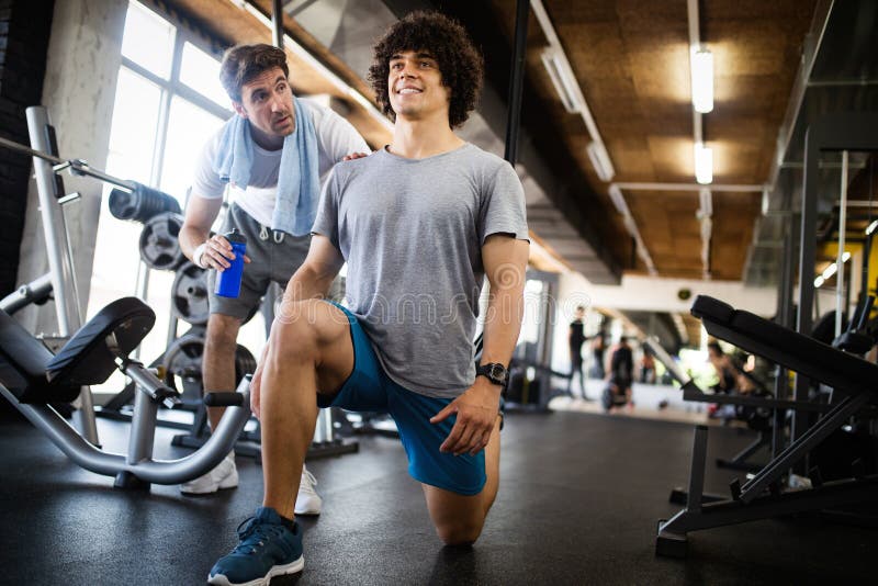 Young Fit Man Doing Workout with a Personal Trainer. Stock Photo ...