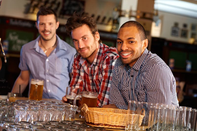 Young Men Drinking Beer at Bar Counter Stock Photo - Image of black ...