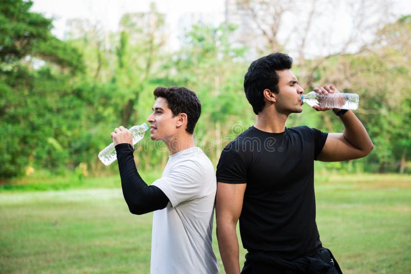 Young Men Drinking Some Water from a Bottle Stock Photo - Image of ...