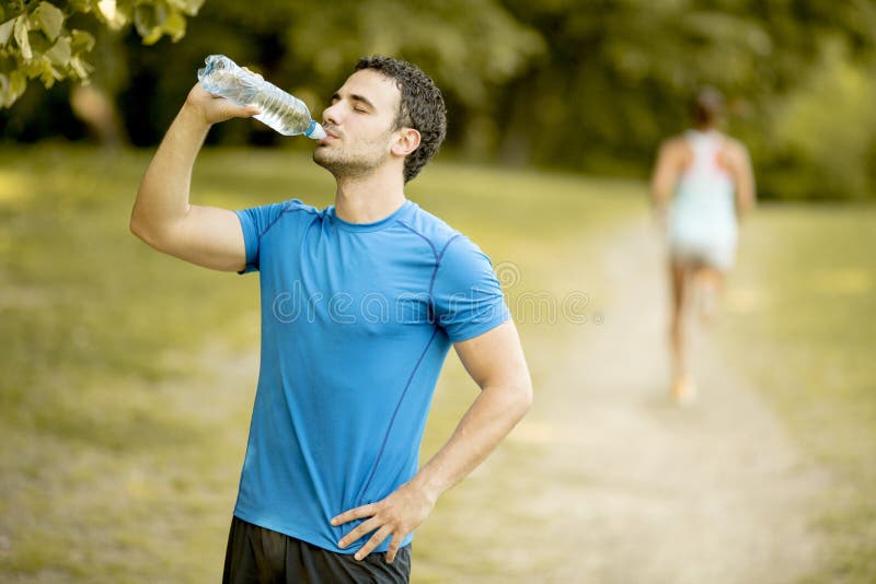 Young man drinking water stock image. Image of tired - 114226741