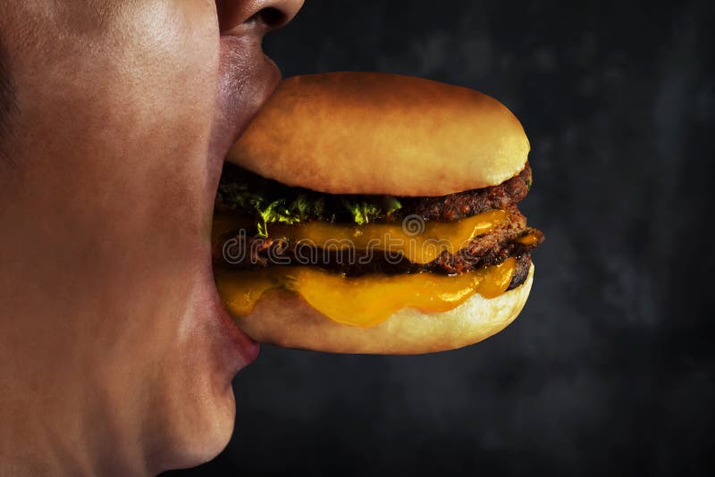 Young Men Eating Cheese Burger Stock Photo - Image of junk, background ...