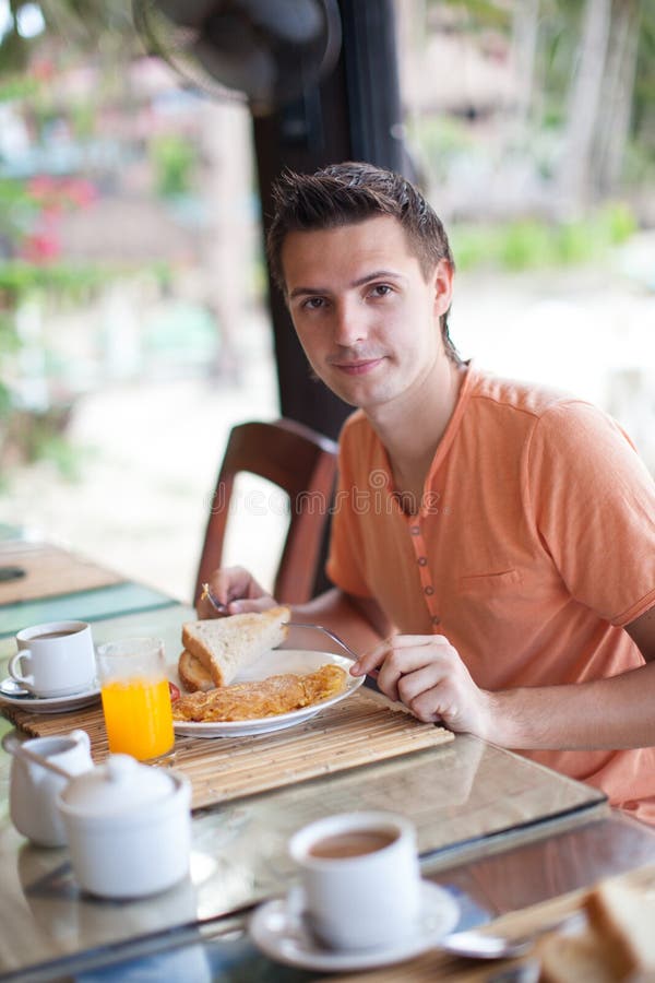 Young Men Having Breakfast at Resort Restaurant Stock Photo - Image of ...