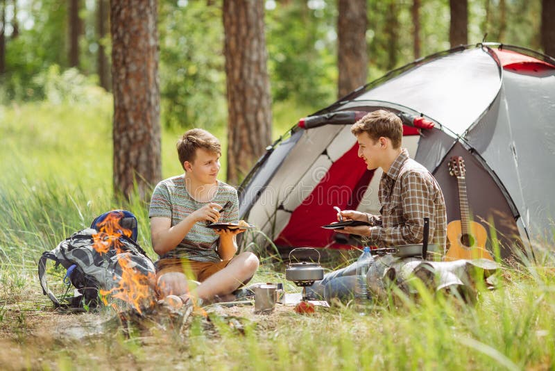 Young Men are Heated in a Fire and Cook Out on a Summer Camp Stock ...