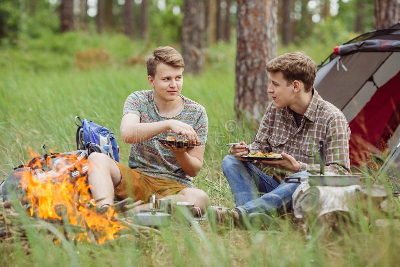 Young Men are Heated in a Fire and Cook Out on a Summer Camp Stock ...