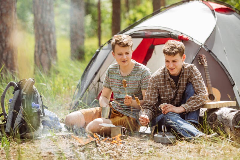 Young Men are Heated in a Fire and Cook Out on a Summer Camp Stock ...