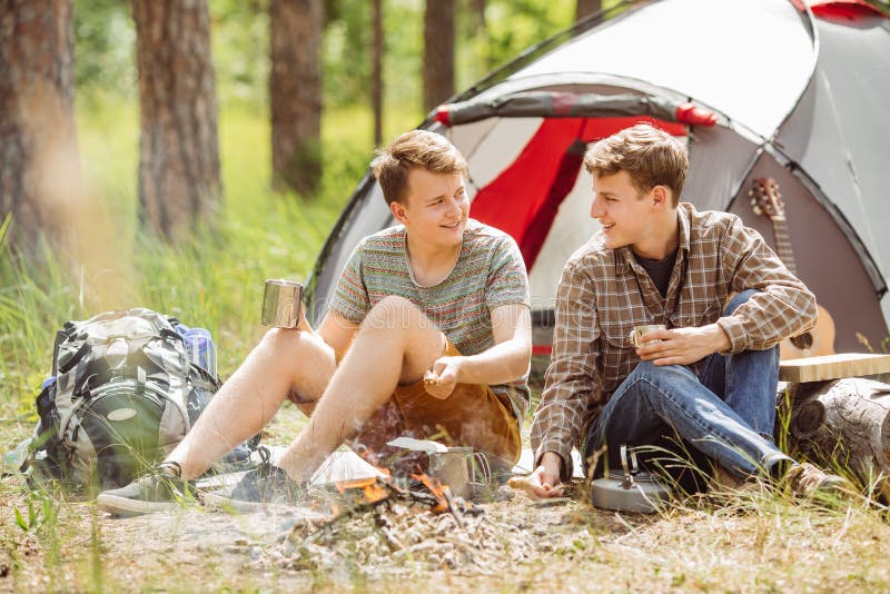 Young Men are Heated in a Fire and Cook Out on a Summer Camp Stock ...