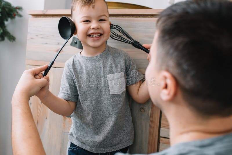 Young Man and His Son with Oven Sheet in Kitchen. Father with Little ...