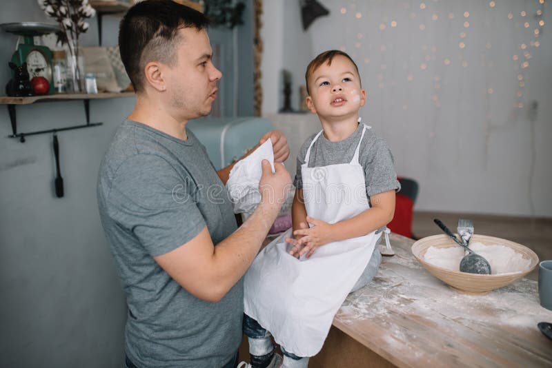 Young Man and His Son with Oven Sheet in Kitchen. Father with Little Son on the Kitchen. Stock ...