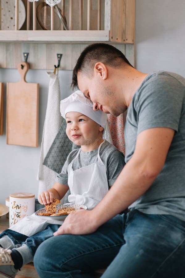 Young Man and His Son with Oven Sheet in Kitchen. Father with Little ...