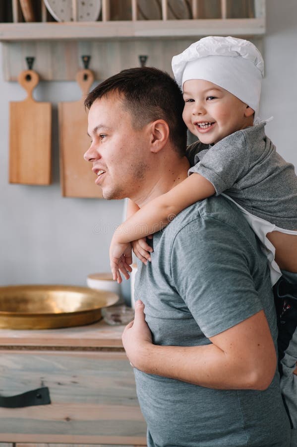 Young Man and His Son with Oven Sheet in Kitchen. Father with Little ...