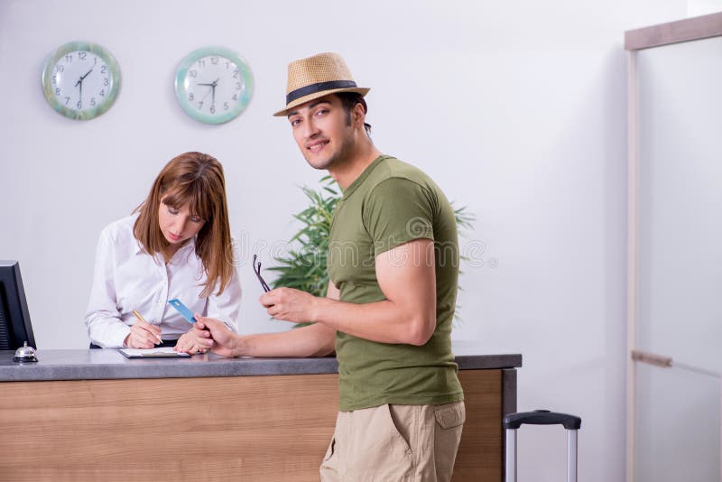 Young Man at the Hotel Reception Stock Image - Image of hotel, checkout ...