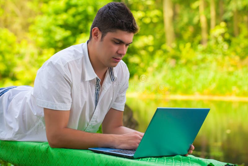 Young men with laptop stock photo. Image of camera, nature - 32896762