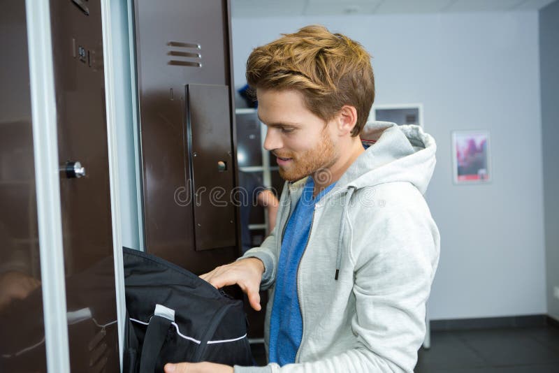 Young man in locker room stock image. Image of university - 101911781