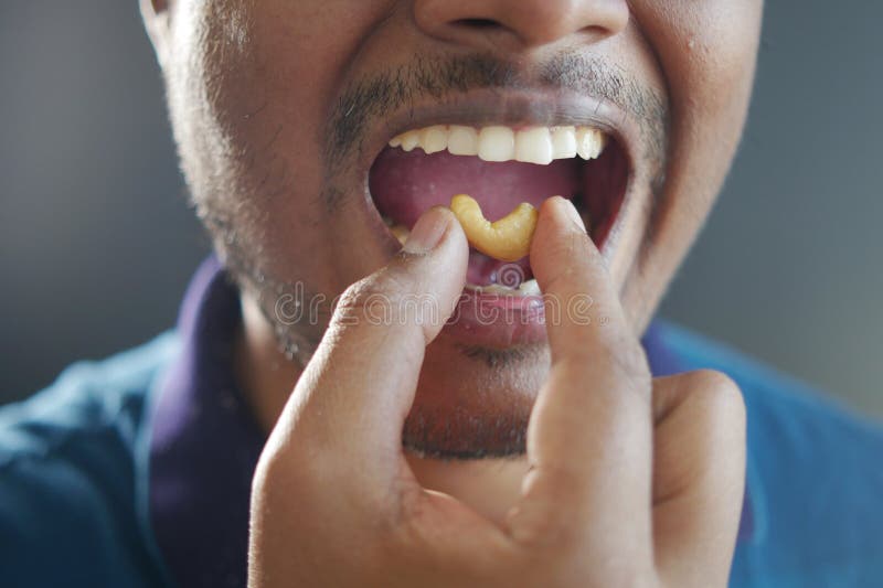 Young Men Mouth Eating Cashew Nuts Stock Photo - Image of nuts ...