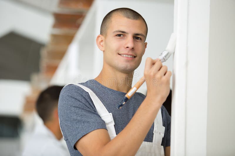 Young Man Painter in Uniform Painting White Wall Stock Image - Image of ...